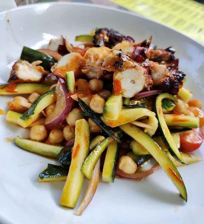 Grilled octopus with pomegranate seeds adding pops of color and flavor that make you rethink everything you know.