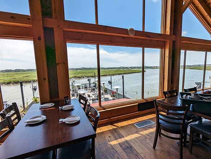 Exposed beams and warm wood create that coastal cabin vibe where flip-flops and fancy both feel welcome.