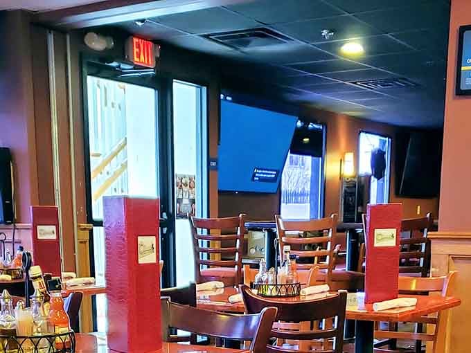 Modern dining space with booth seating and sports jerseys on walls blending comfort with casual Brazilian hospitality perfectly.