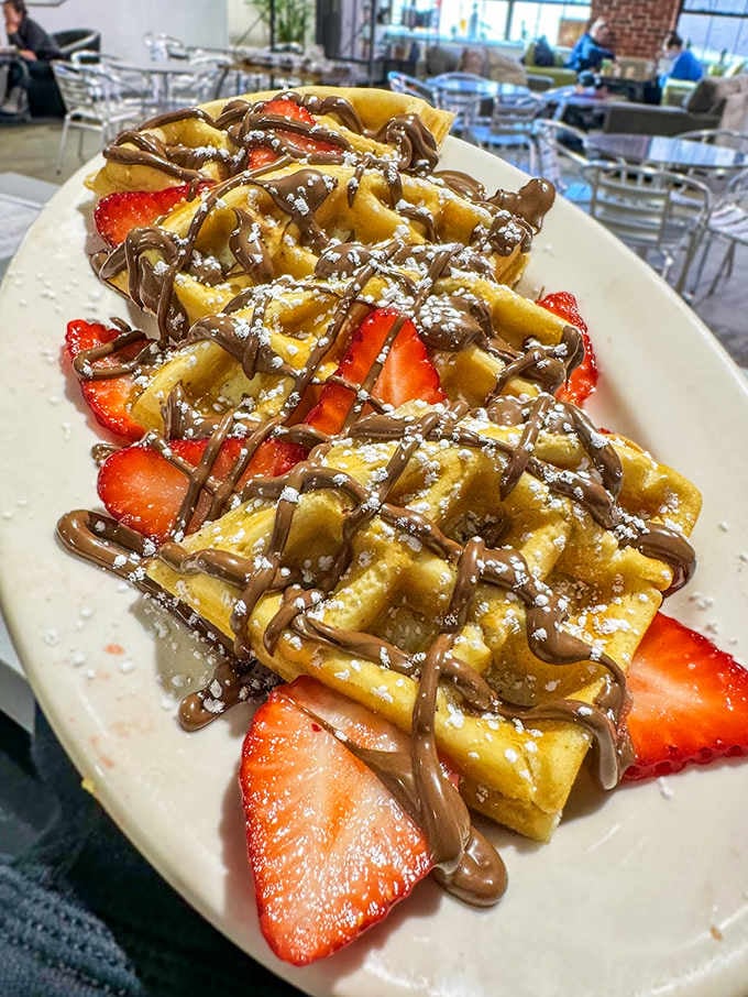 Strawberries, Nutella, and waffles unite in a breakfast creation that makes counting calories feel utterly pointless.