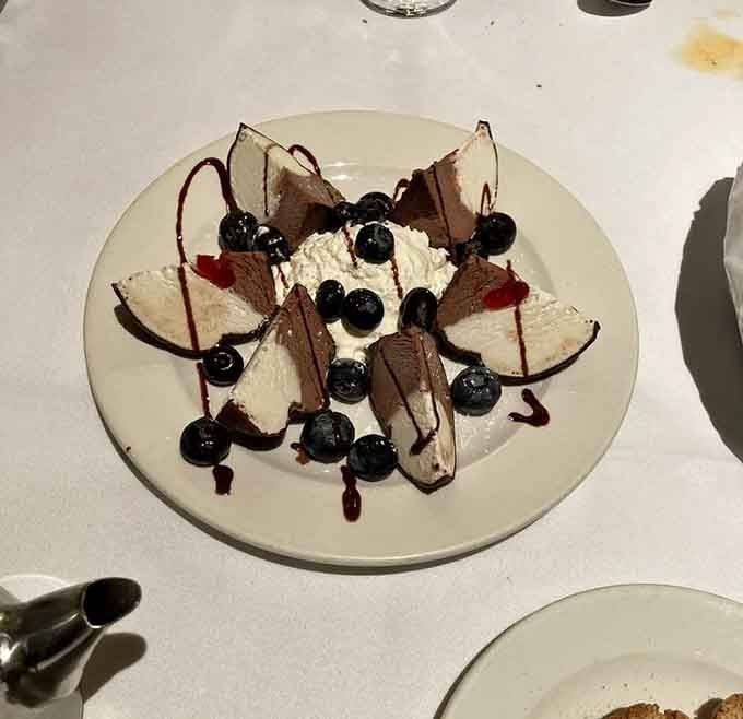 The tartufo arrives like a chocolate sculpture, proving dessert can be both art and pure indulgence simultaneously.