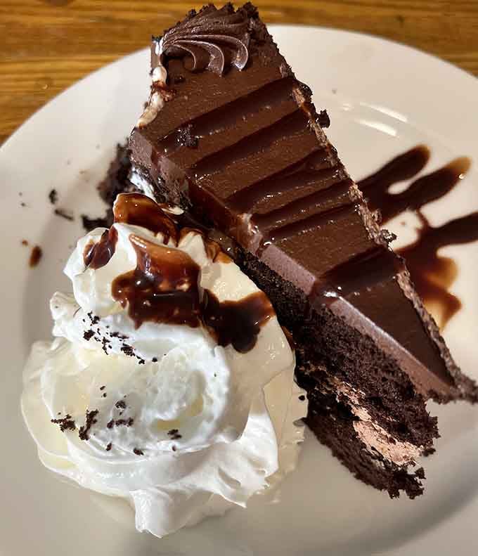 This towering chocolate cake slice with whipped cream is why dessert menus exist in the first place.