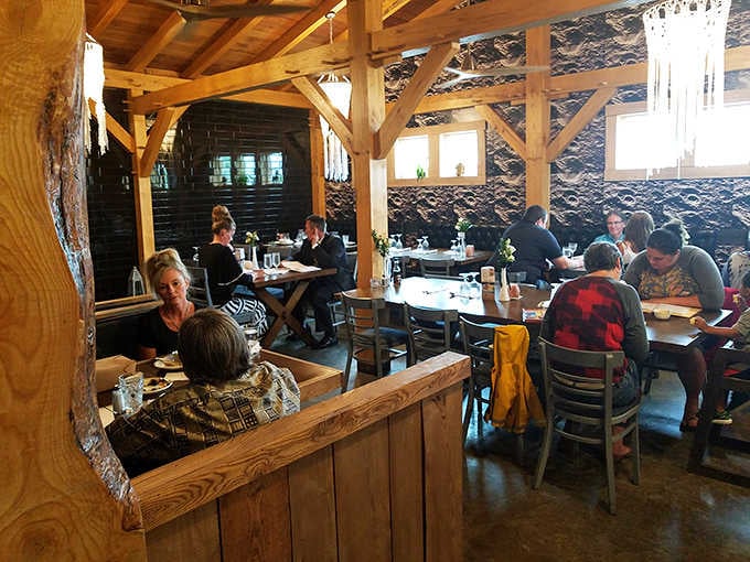 Exposed timber framing and elegant chandeliers create an atmosphere that's both rustic and surprisingly refined inside.