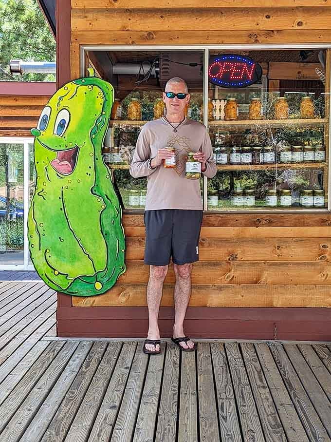Nothing says "I love pickles" quite like posing with a giant smiling cucumber mascot on a mountain porch.