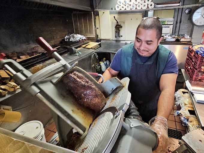 The meat slicer is the real MVP here, turning charcoal-kissed beef into thin, tender slices of pure happiness.