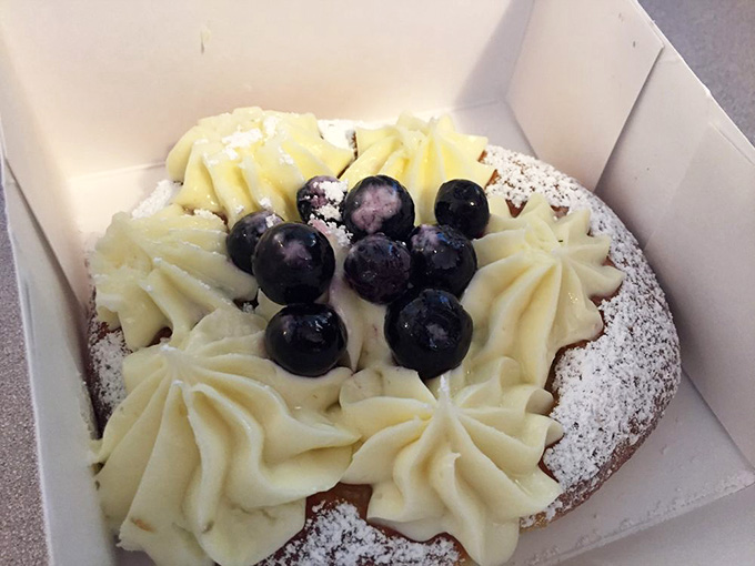 Cream rosettes and fresh berries crown this pastry like it's royalty, which honestly isn't far from the truth here.