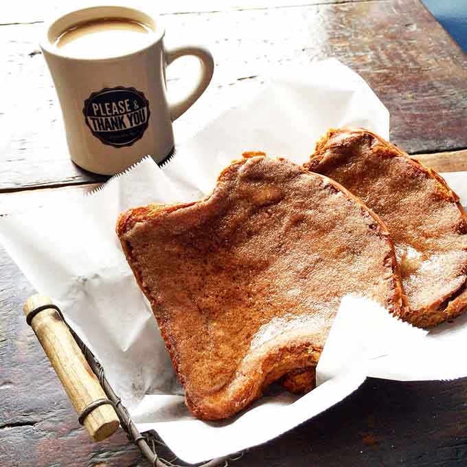 A Kentucky-shaped cinnamon toast cookie next to coffee is basically state pride you can eat, and that's beautiful.