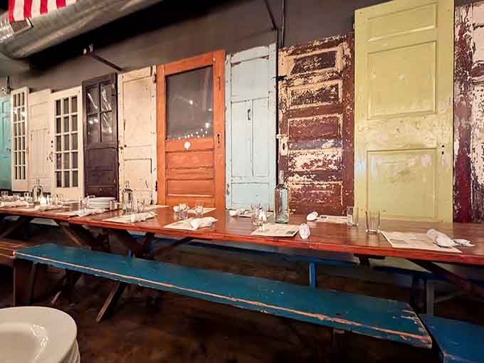 Mismatched vintage doors line the wall like a quirky art installation that also happens to be functional.