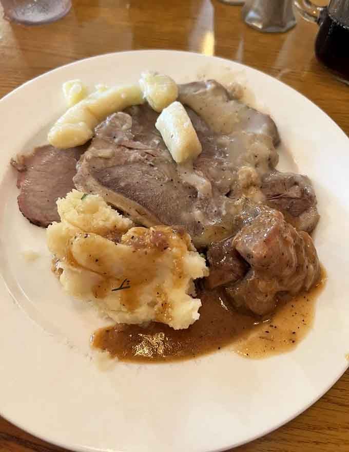 Mashed potatoes, tender pork, and gravy creating the kind of comfort food trinity that makes everything feel okay.