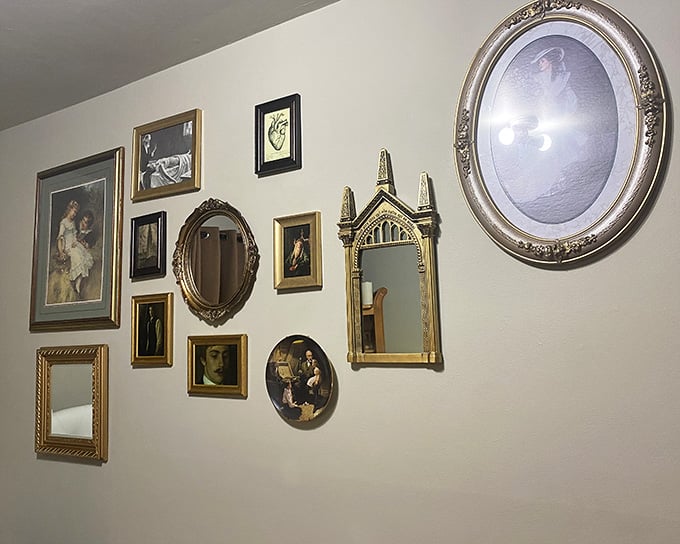 Vintage frames and mirrors create an eclectic gallery wall display that interior designers would charge thousands to recreate.