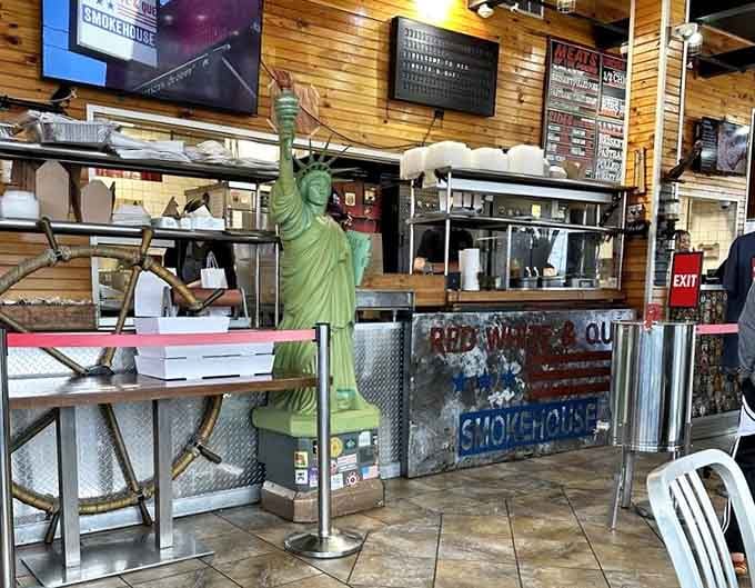 Counter service with a Statue of Liberty keeping watch, because freedom means choosing between brisket and pulled pork.