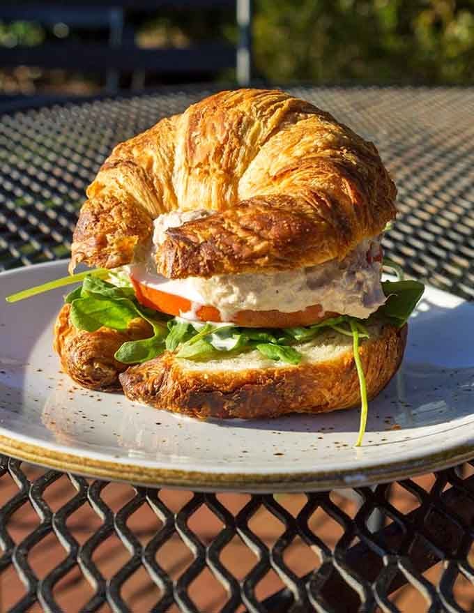 A flaky croissant sandwich that makes you question why you ever settled for regular bread options.