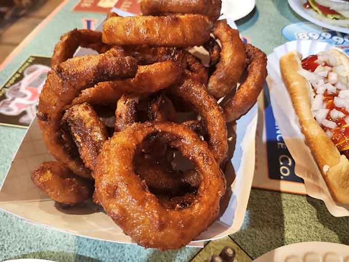 These onion rings achieve the golden-brown perfection that separates the amateurs from the pros in frying.
