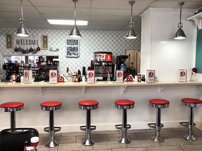 Classic diner counter with red stools invites solo diners to settle in for breakfast conversation.