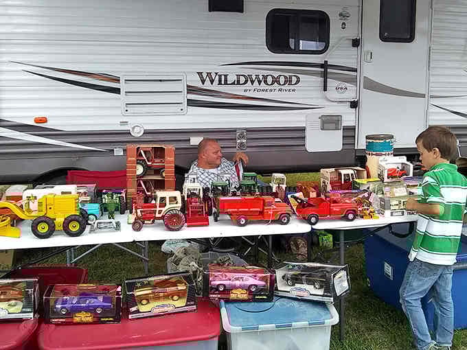 This toy truck collection represents someone's childhood dreams and another person's future nostalgia, all displayed on folding tables under Missouri skies.
