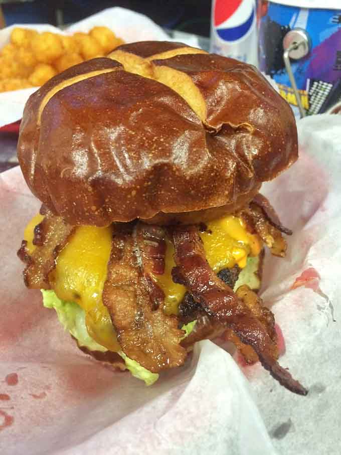 Bacon cascading over a pretzel bun like a delicious waterfall, because regular buns are for regular burgers.