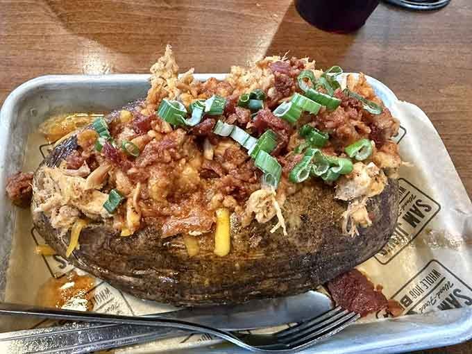 A loaded baked potato topped with pulled pork, cheese, and bacon turns a simple side into a meal.