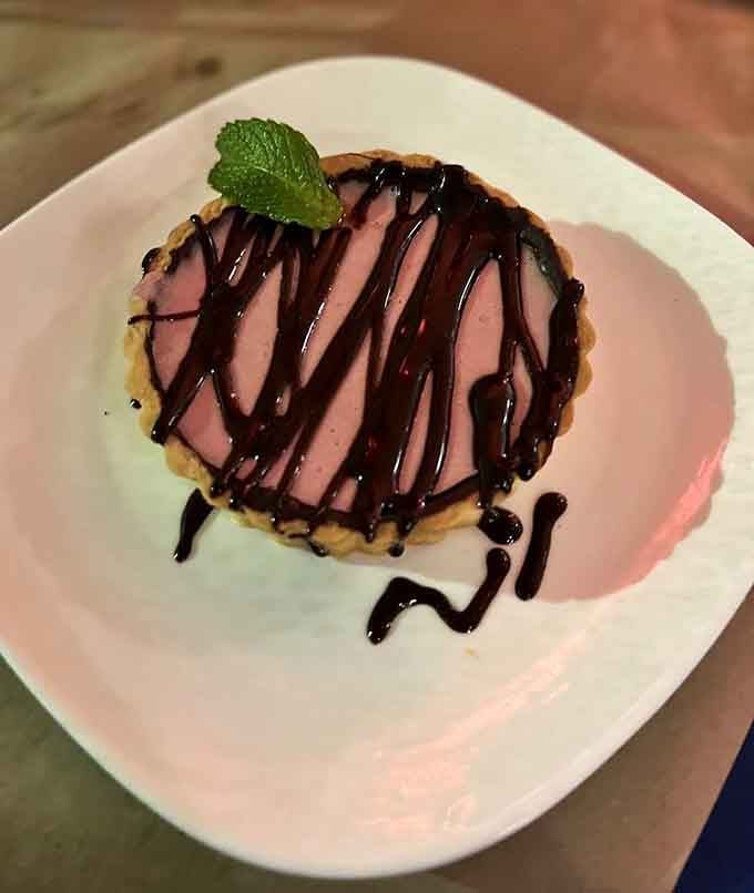 Dessert arrives looking like it got dressed up for a night out on the town, complete with chocolate drizzle.