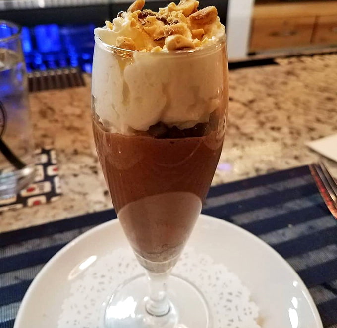 Hazelnut mousse topped with crushed nuts transforms dessert into a moment of pure, unapologetic indulgence.