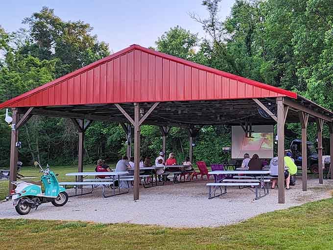 The red-roofed pavilion offers shelter and community, perfect for potlucks or escaping sudden summer showers.