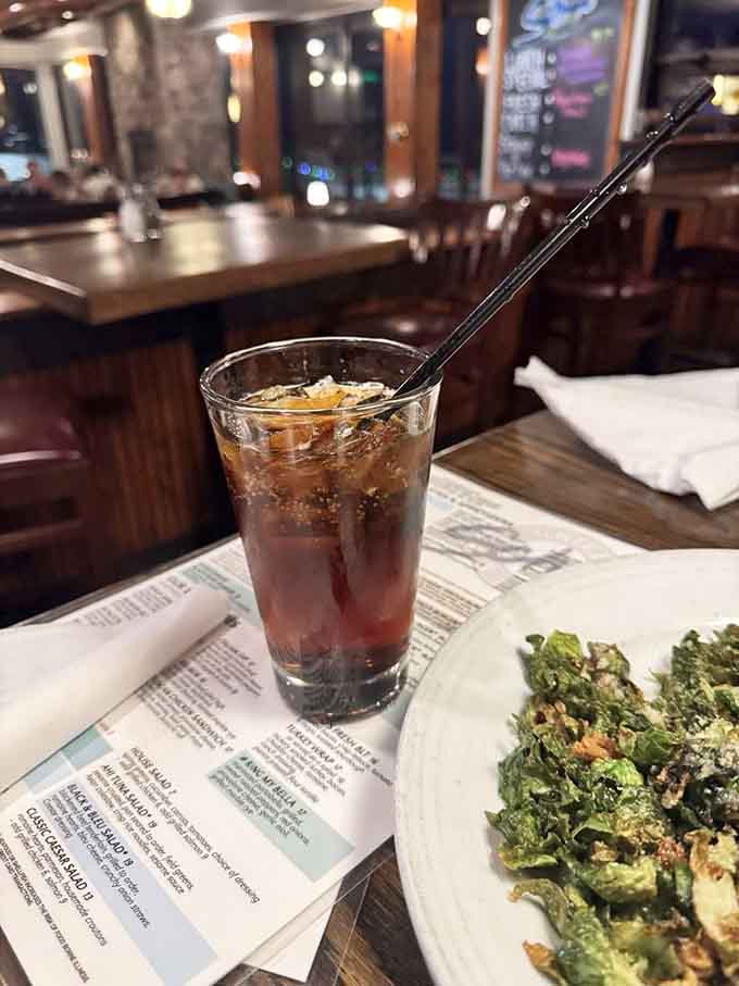 Root beer in a proper glass with a metal straw, proving some traditions deserve to stick around forever.