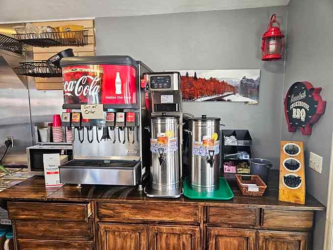 The beverage station stands ready with cold drinks and condiments, because great barbecue deserves equally great supporting cast members nearby.