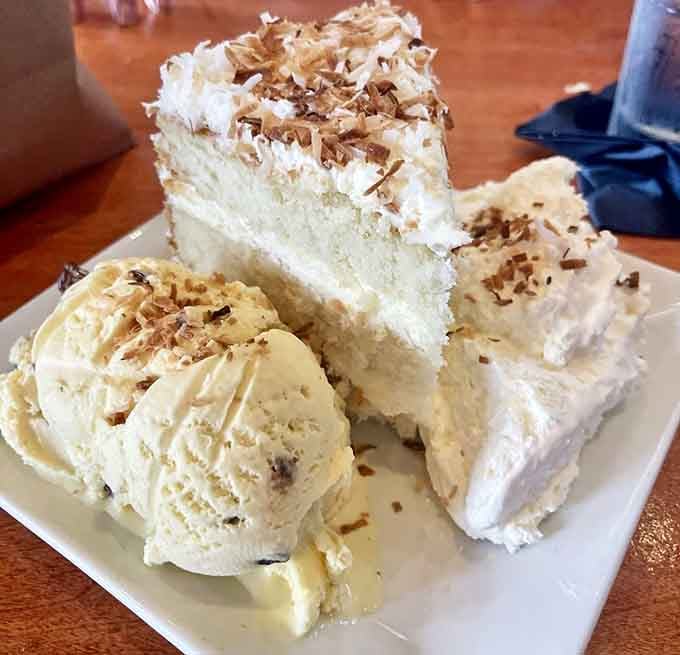 Coconut cake towers high with fluffy layers and ice cream, because you absolutely deserve dessert after that seafood feast.
