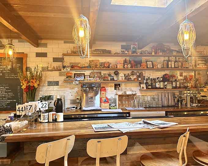 The bar area gleams with possibility, where whisk-shaped lights hang like edible art above shelves of breakfast dreams.