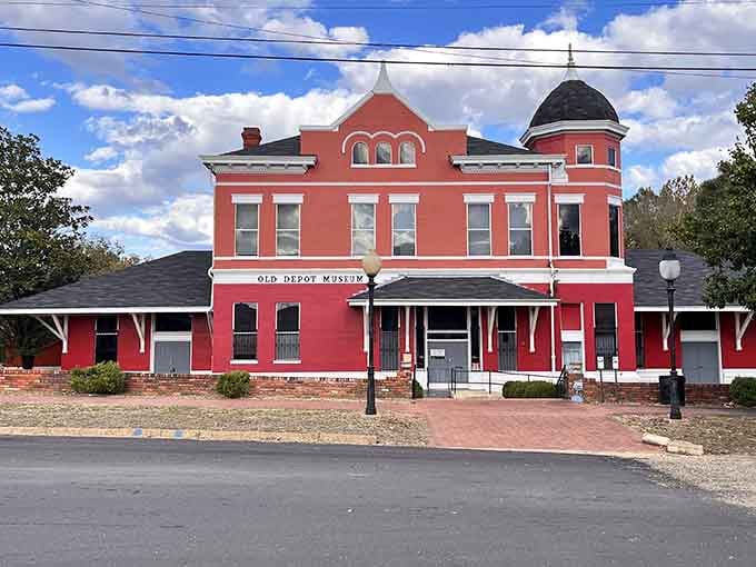 The Old Depot Museum stands proud in coral pink, proving that historic preservation can be both educational and surprisingly photogenic.