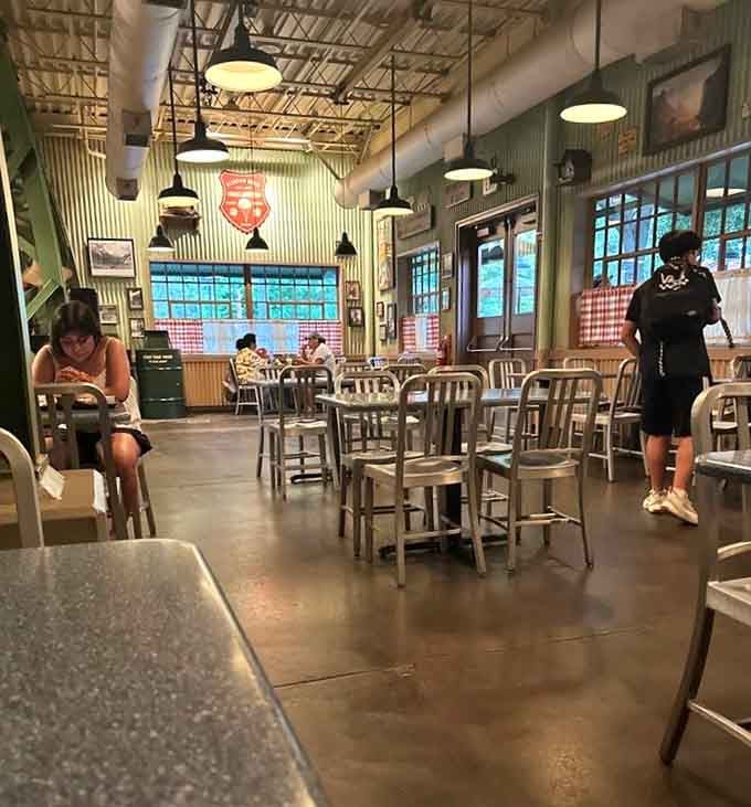 Spacious seating under industrial lighting creates an atmosphere that's both functional and surprisingly comfortable for theme park dining.