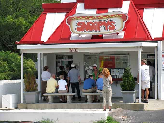 Real people gathering at outdoor tables, the kind of community scene that makes a restaurant feel like home.
