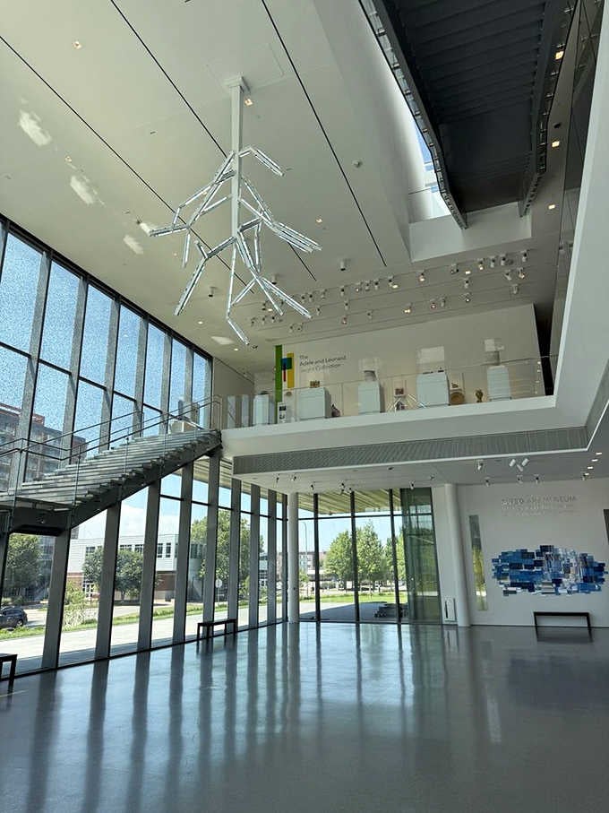 Soaring glass walls and geometric ceiling sculptures make the entrance feel like stepping into tomorrow's museum today.