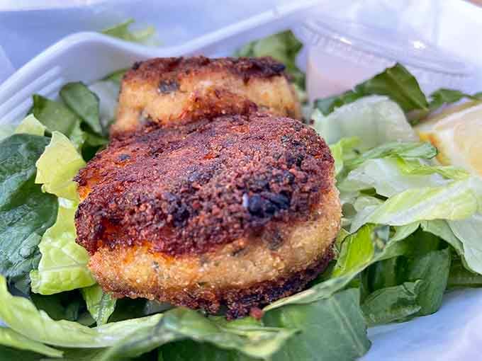 Golden-crusted crab cakes on lettuce beds look like they graduated summa cum laude from seafood university.