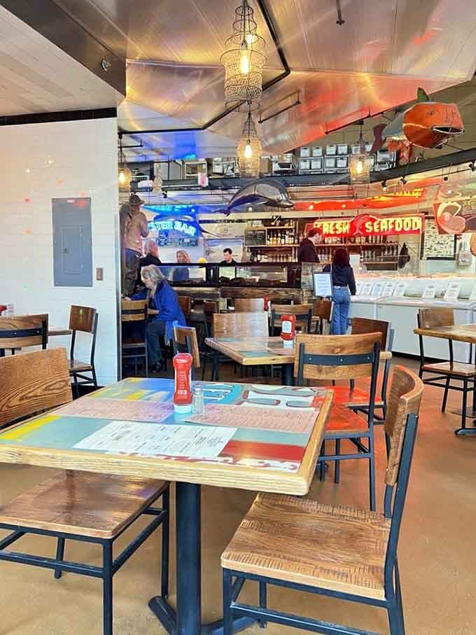 Colorful tables and whimsical fish decor create a fun, relaxed atmosphere where serious seafood meets serious good times.