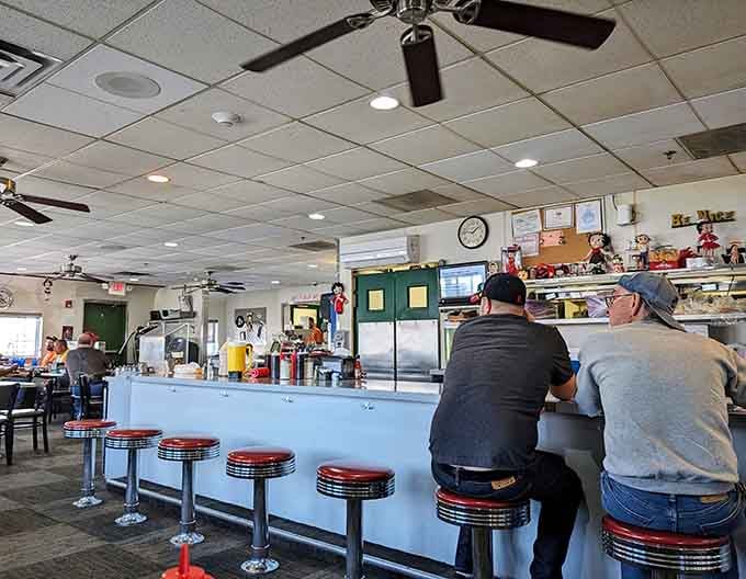 Classic chrome stools line the counter where diners become part of the show, not just spectators.