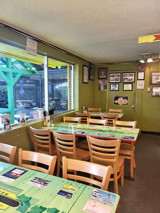 Bright green walls and wooden chairs create a welcoming space where strangers become friends over shared plates of joy.