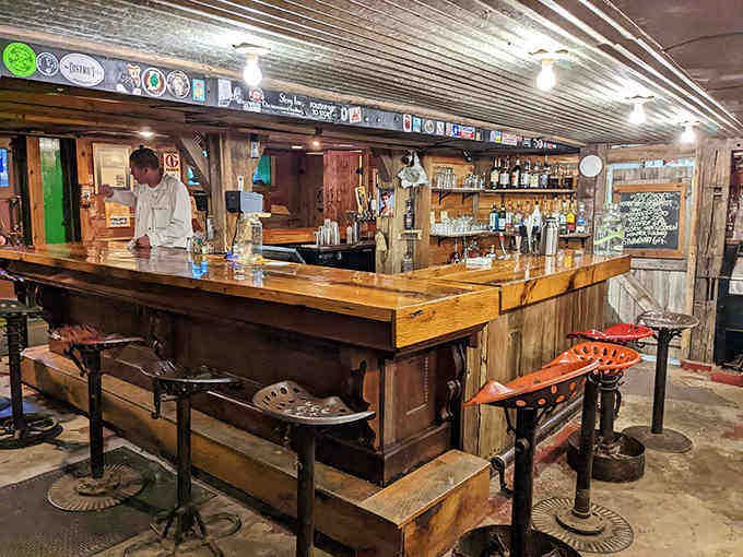 The basement bar transforms historic space into cozy gathering spots where stories flow as freely as the drinks.