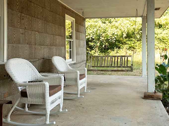 Vintage chairs and a wooden swing create the perfect spot for contemplating your good fortune at snagging this reservation.