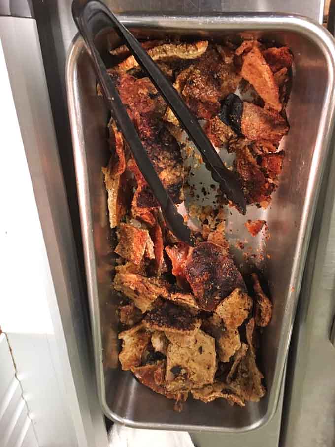 Crispy pork skin that crackles with flavor, proving that good things really do come to those who wait by the pit.