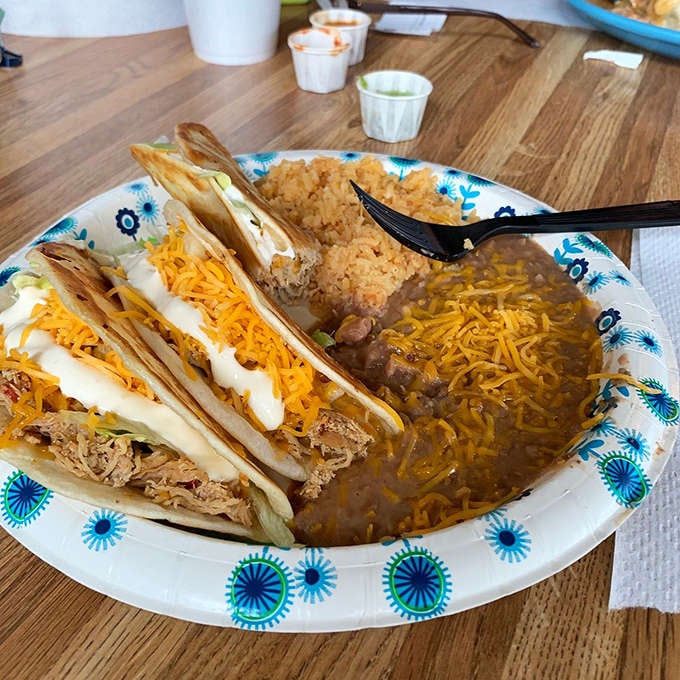 Crispy tacos with rice, beans, and what appears to be perfectly fried chicken: the holy trinity of satisfaction.
