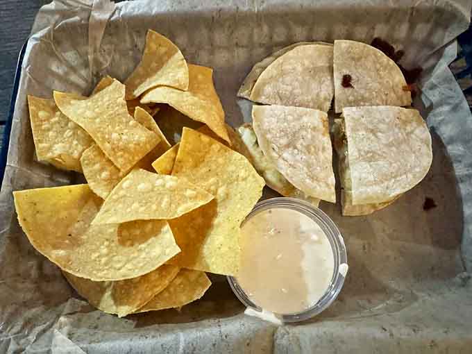 Crispy quesadilla wedges with chips and creamy sauce, comfort food that bridges cultures and satisfies every craving.