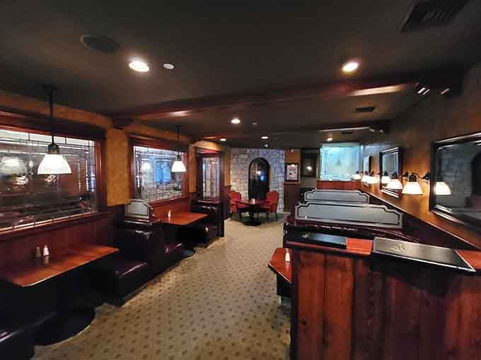 Spacious booths and warm lighting create intimate corners where conversations flow as smoothly as the wine.