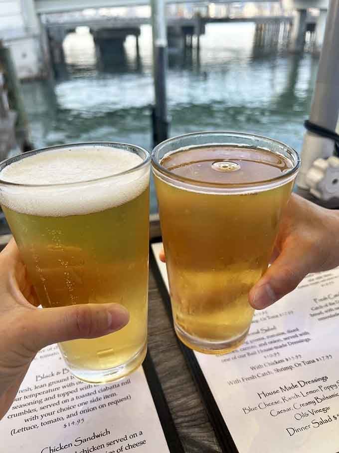 Two cold beers with harbor views behind them taste exactly like summer vacation feels, even on a Tuesday afternoon.