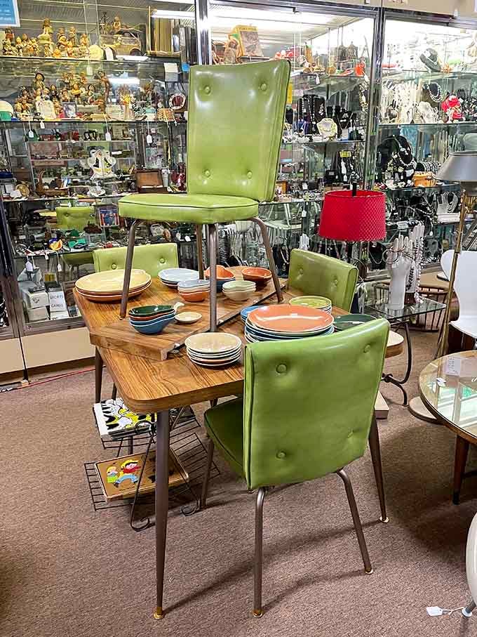 Avocado green vinyl chairs surround a blonde wood table, screaming Mad Men louder than Don Draper himself.