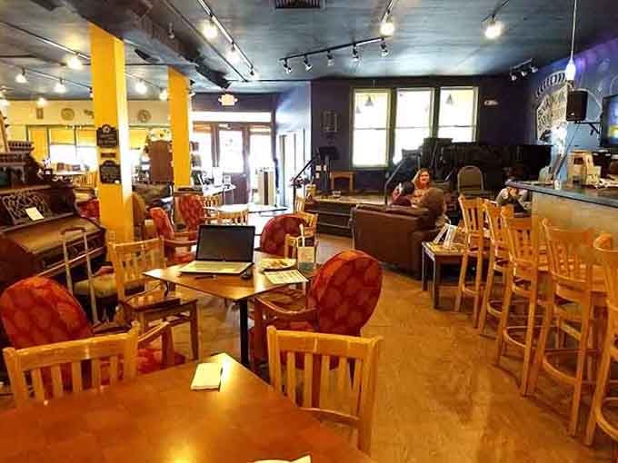 Sunlight streams through windows onto wooden tables where strangers become friends over shared stories and strong coffee.