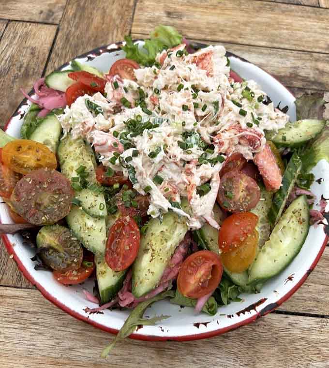 Fresh lobster piled high on greens with heirloom tomatoes, because salads can be decadent too when done right.