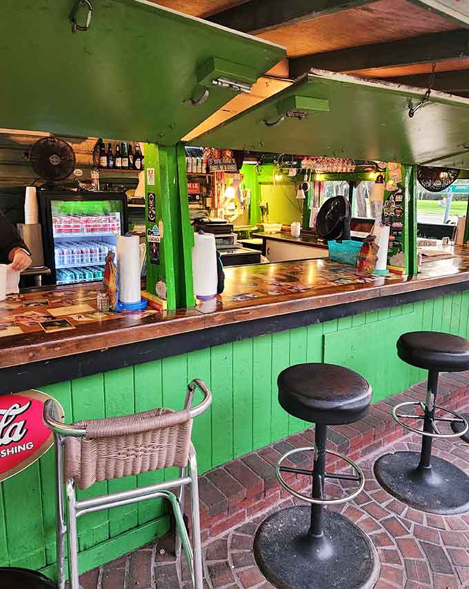 The bright green counter and brick floor combo shouldn't work together, but somehow this cheerful chaos makes perfect sense here.