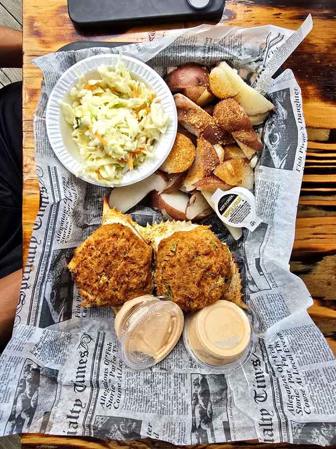 Crab cakes golden and crispy, flanked by potatoes and coleslaw like the supporting cast they are.