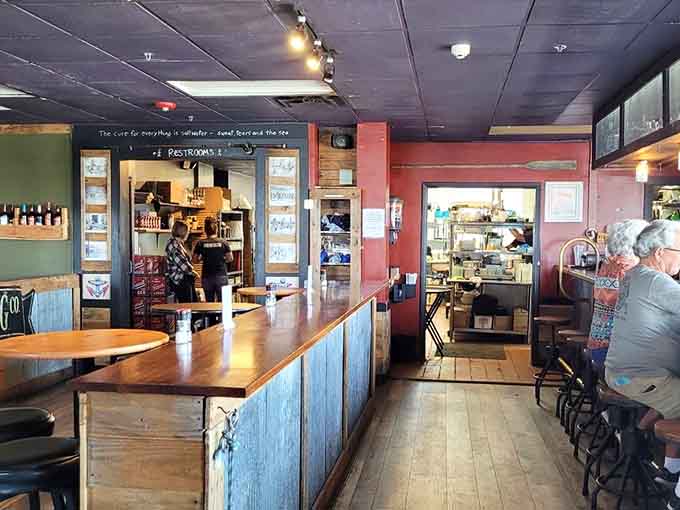 The bar area features corrugated metal accents and nautical touches, creating that perfect spot for a cold drink before dinner.