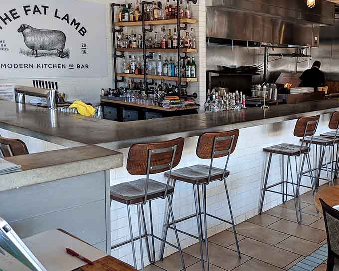 The bar area gleams with bottles and possibilities, inviting you to settle in for serious cocktail exploration.